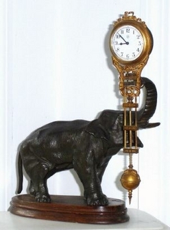 Swing Arm Clock; Junghans, Elephant, Wood Base, 11 inch.